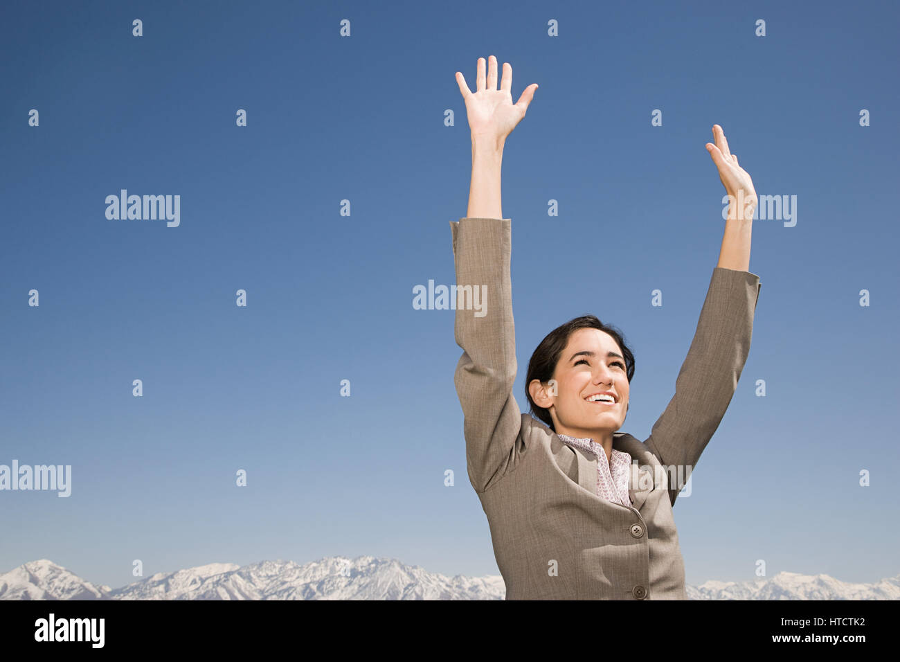 Businesswoman with arms raised Stock Photo - Alamy