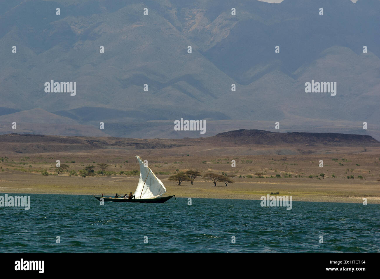 Fisherman in a traditional canoe plowing through the waters of the ...