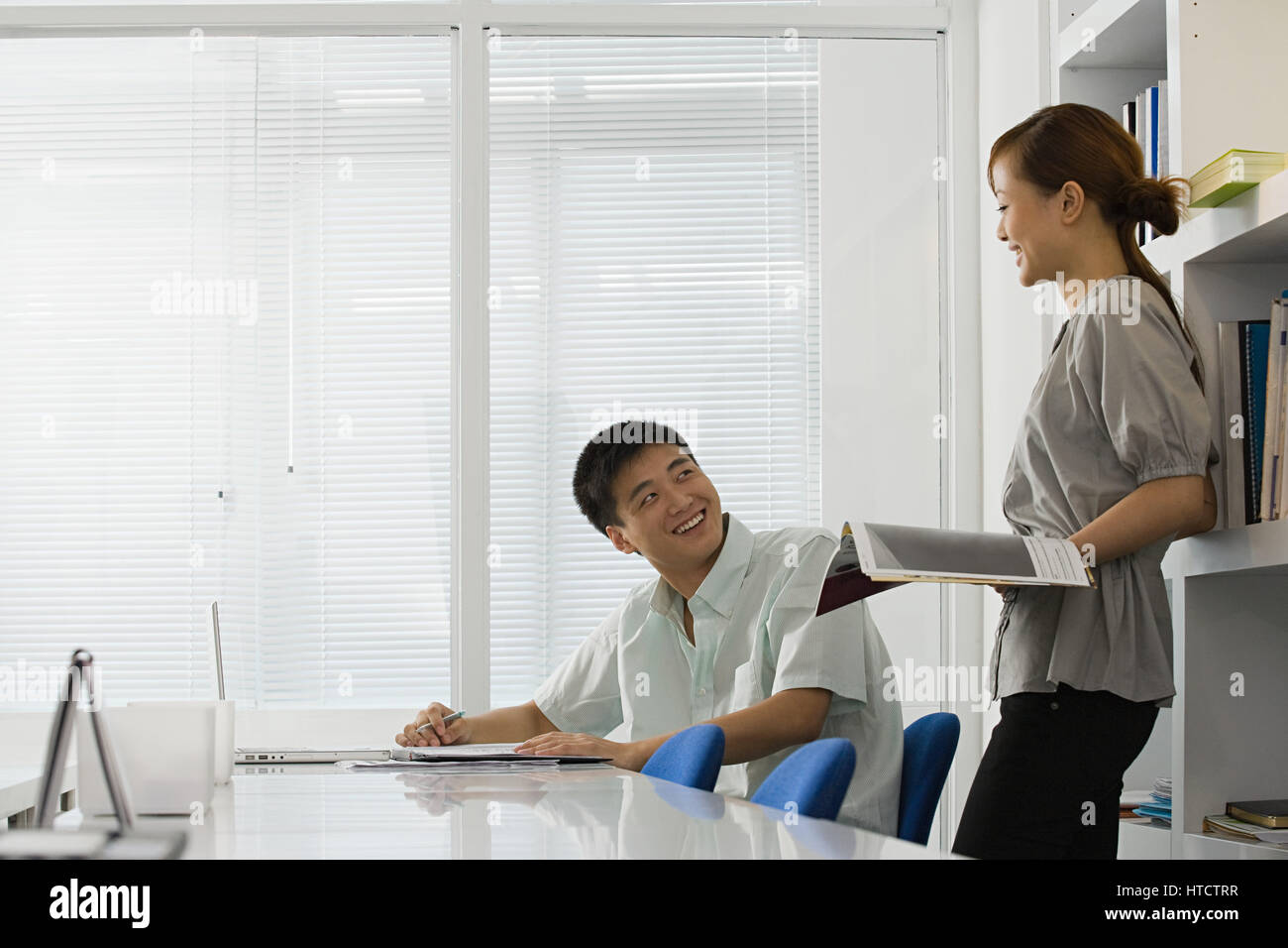 Colleagues in office Stock Photo - Alamy
