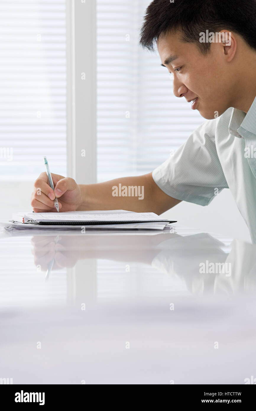 Office worker writing Stock Photo - Alamy