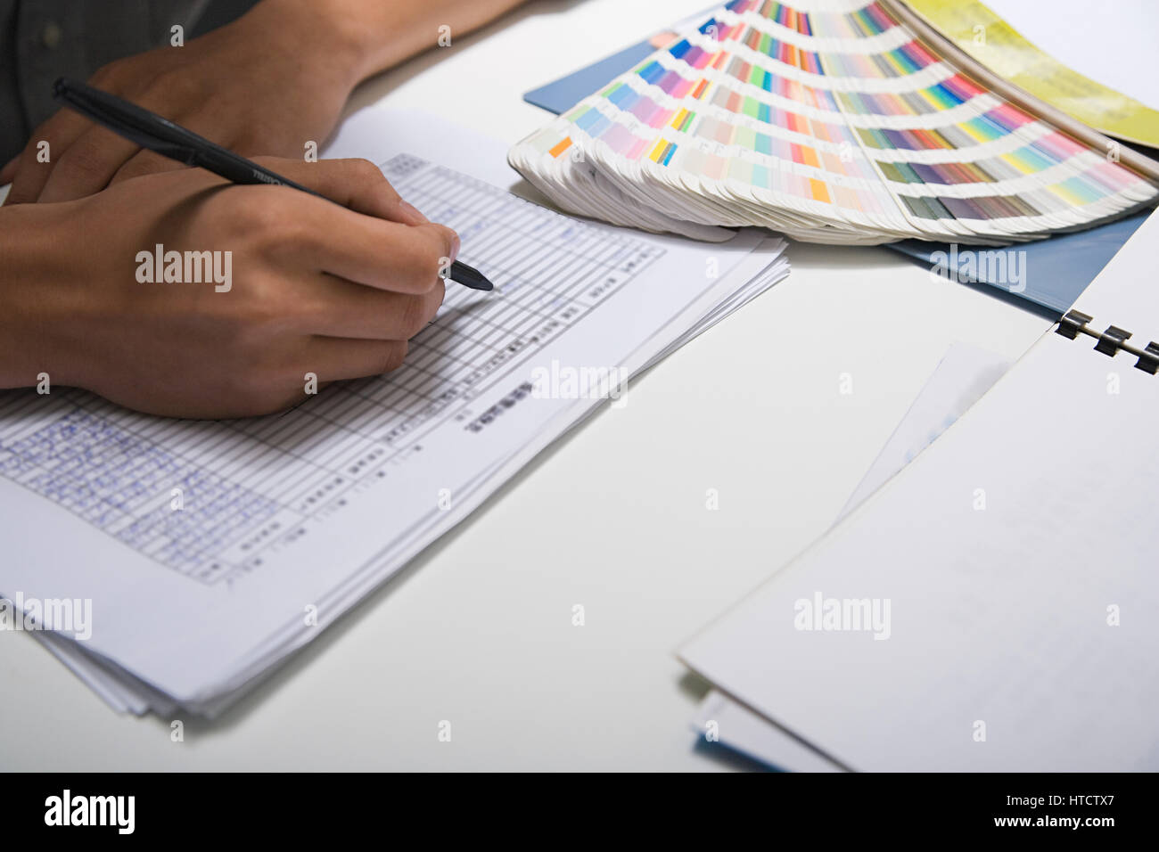 Person filling in sales report Stock Photo - Alamy