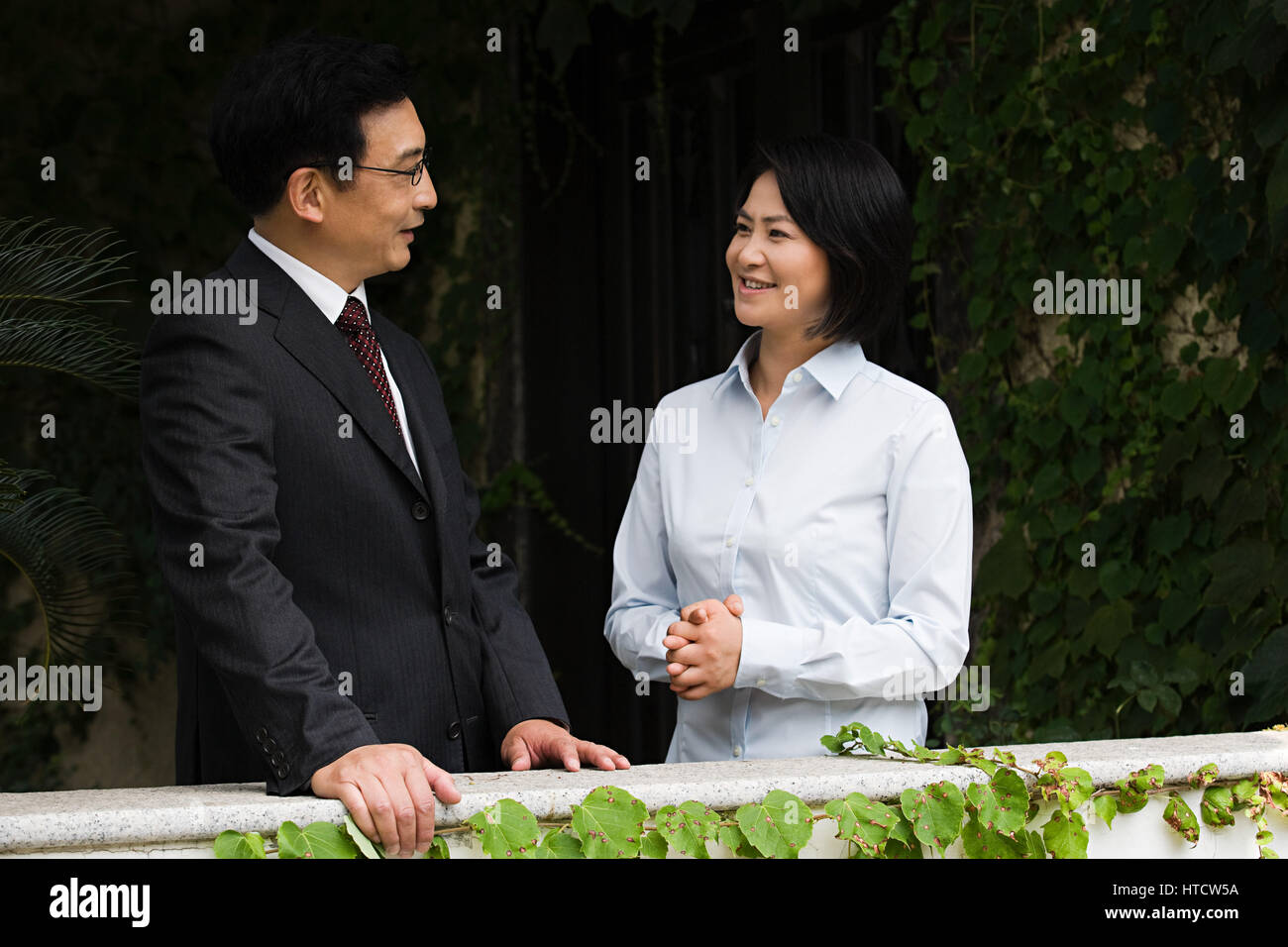 Talking colleagues green shirt hi-res stock photography and images - Alamy