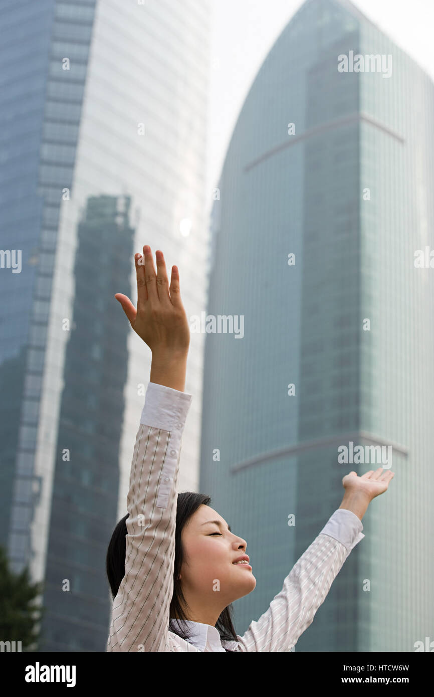 Young woman raising arms above hi-res stock photography and images - Alamy