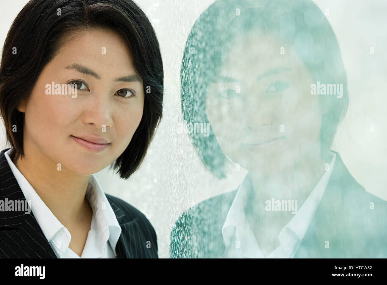 One person reflected in building window hi-res stock photography and ...