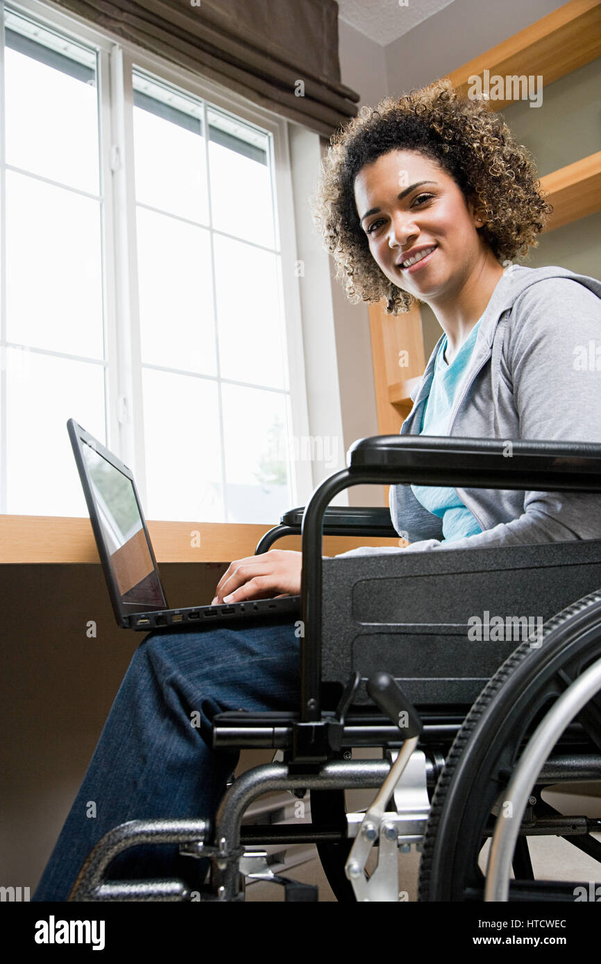 Disabled woman using a laptop computer Stock Photo - Alamy