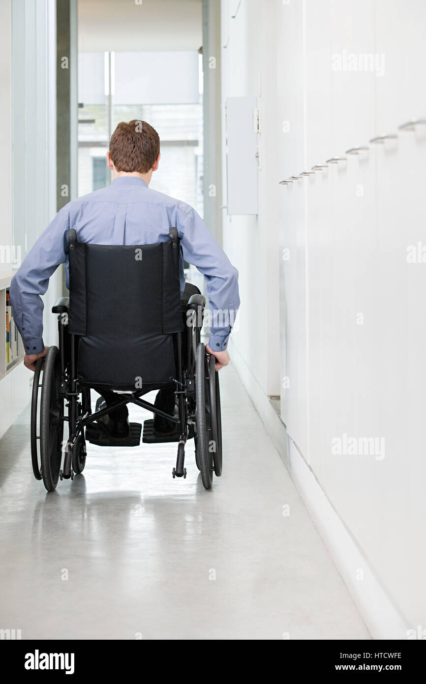 Rear view of a man in a wheelchair Stock Photo - Alamy