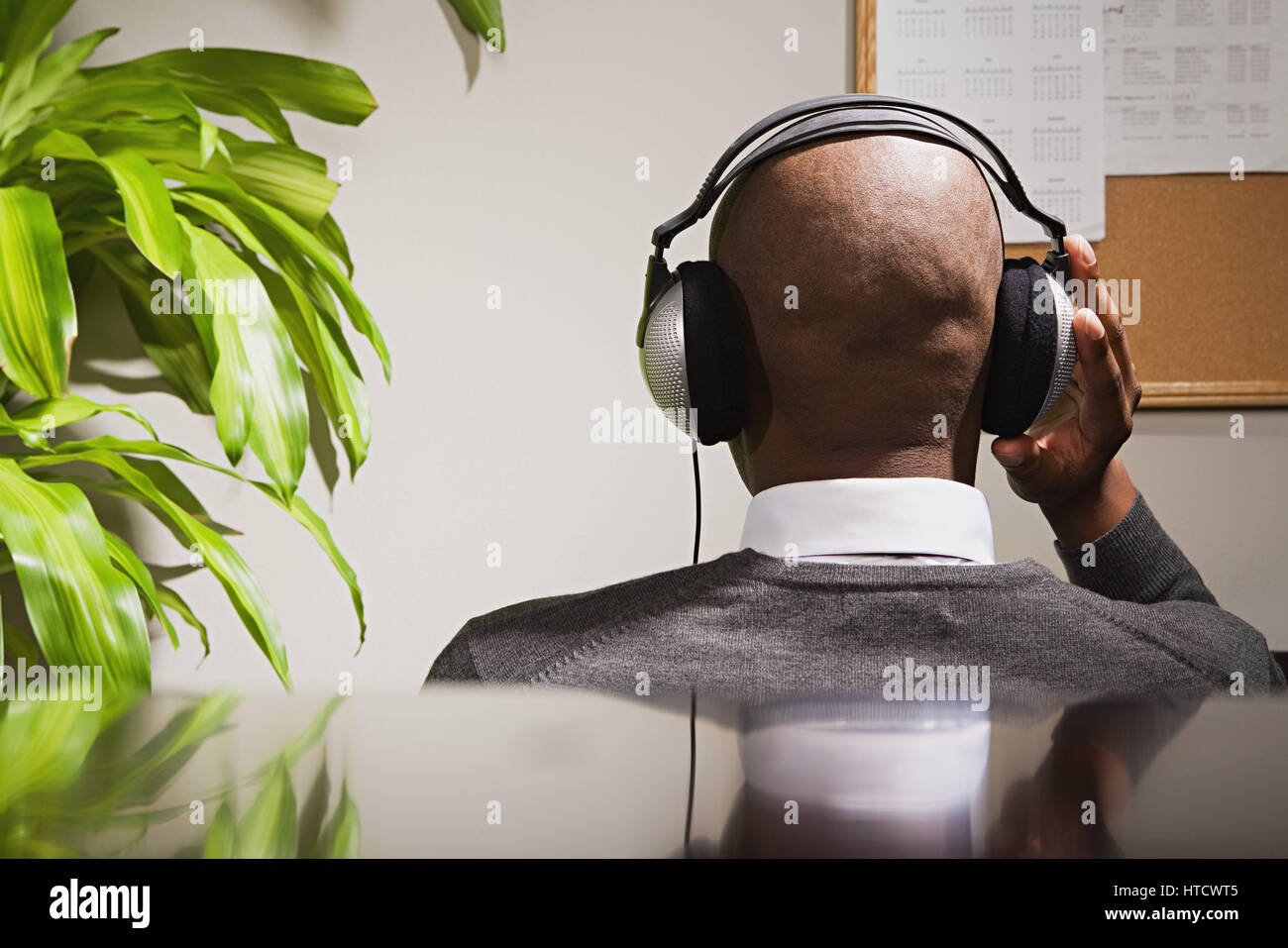 Businessman wearing headphones Stock Photo - Alamy
