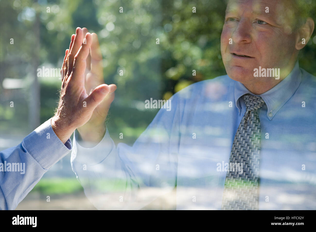 Man looking at his reflection Stock Photo - Alamy