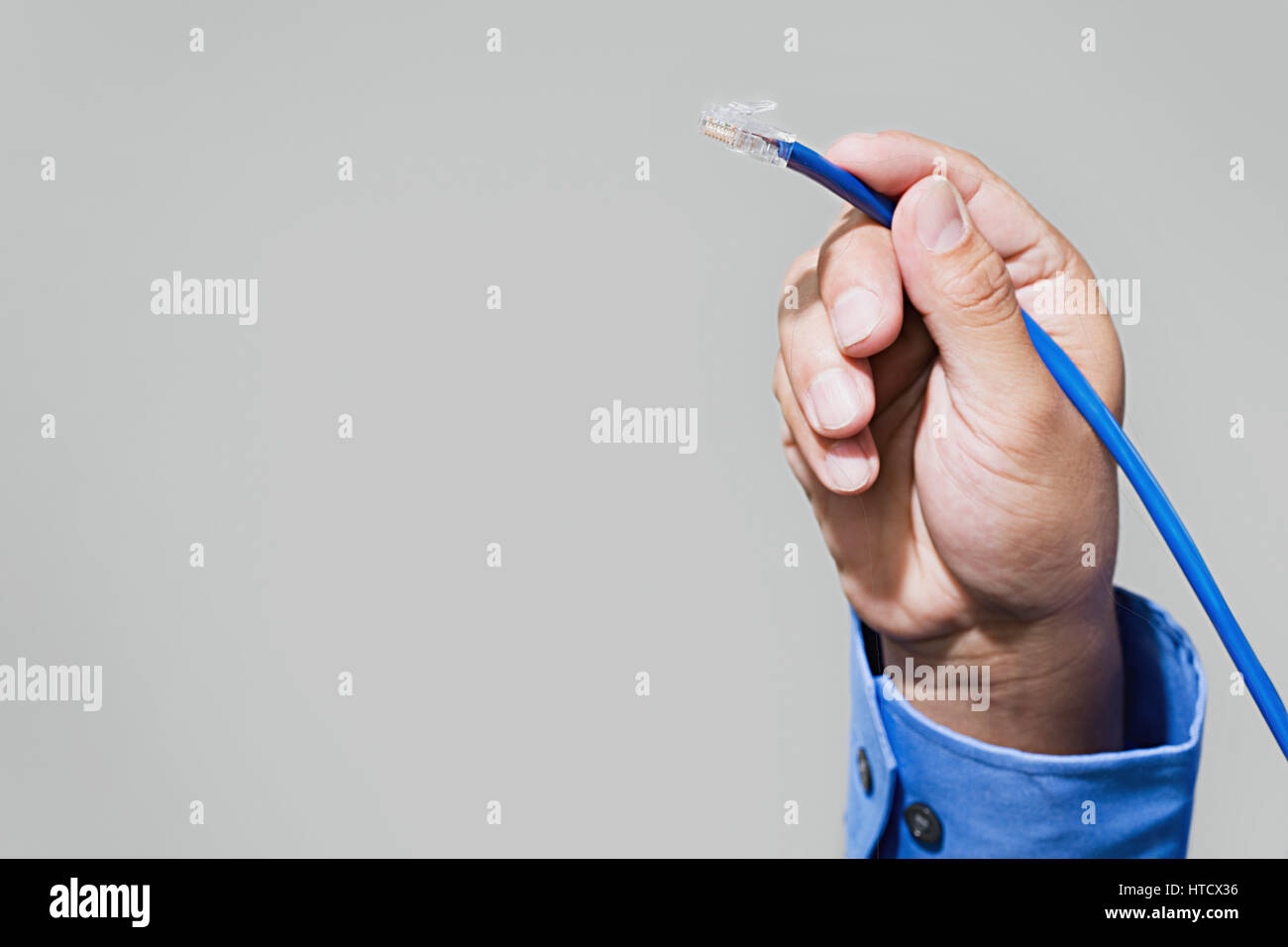 Man holding a network cable Stock Photo - Alamy