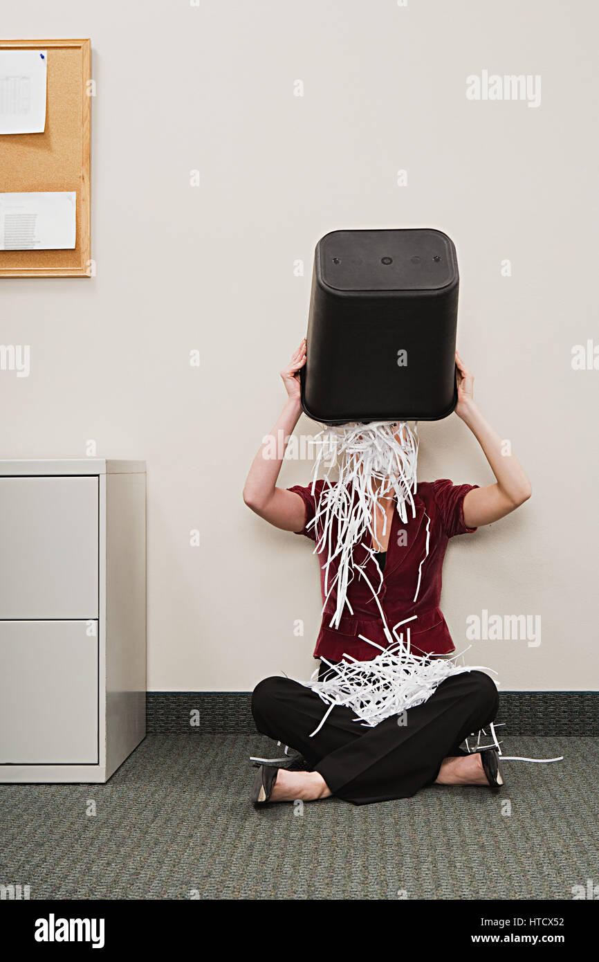 Woman tipping shredded paper over herself Stock Photo - Alamy