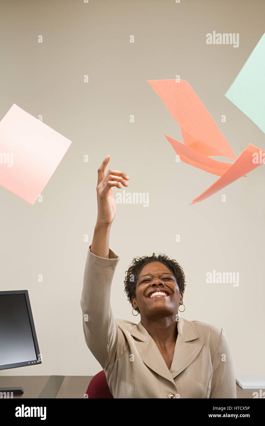 Woman throwing papers in the air Stock Photo - Alamy