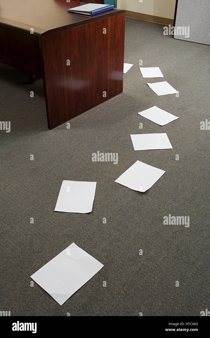 Trail of paper in office Stock Photo - Alamy