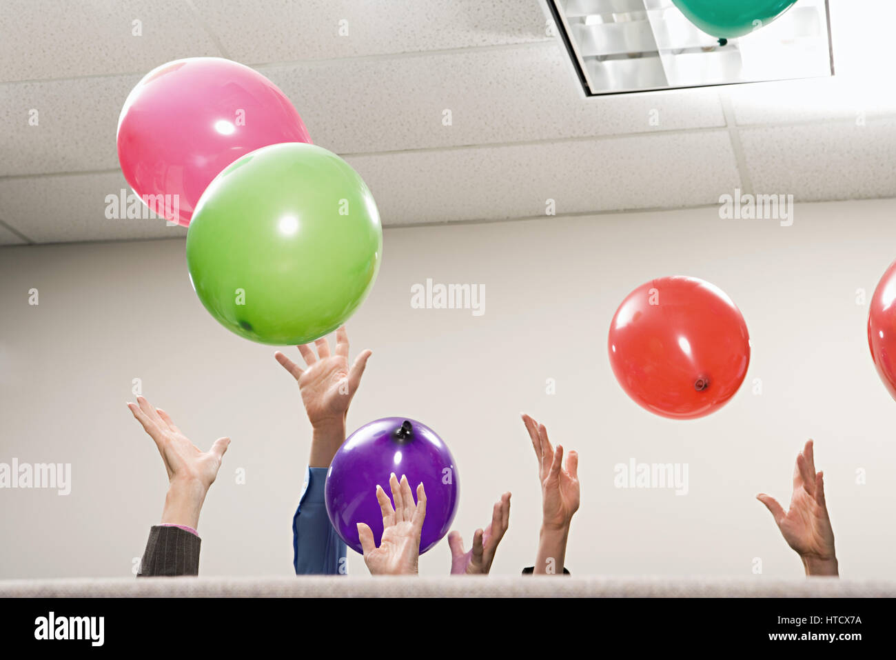 Office workers playing with balloons Stock Photo - Alamy