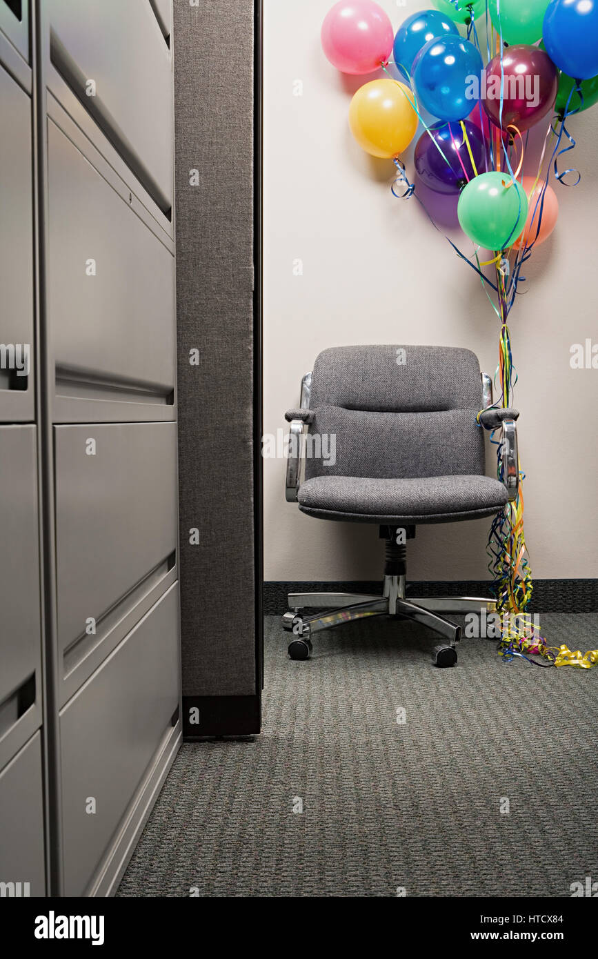 Bunch of balloons tied to office chair Stock Photo - Alamy