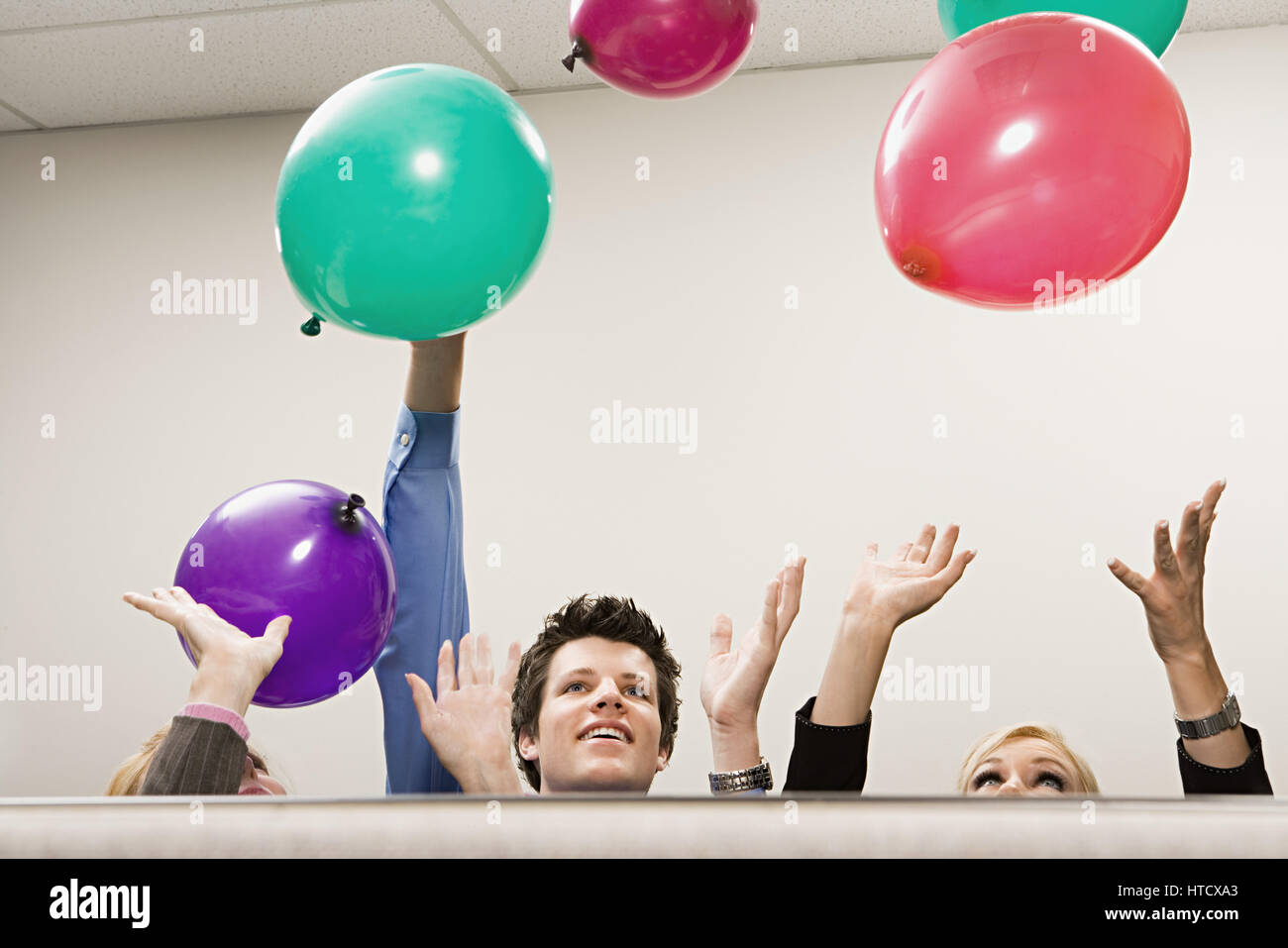 Office workers playing balloons hi-res stock photography and images - Alamy
