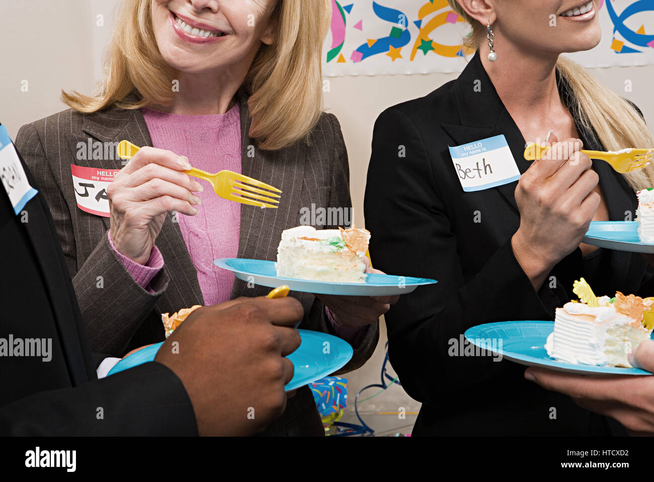 Four office workers eating cake Stock Photo - Alamy