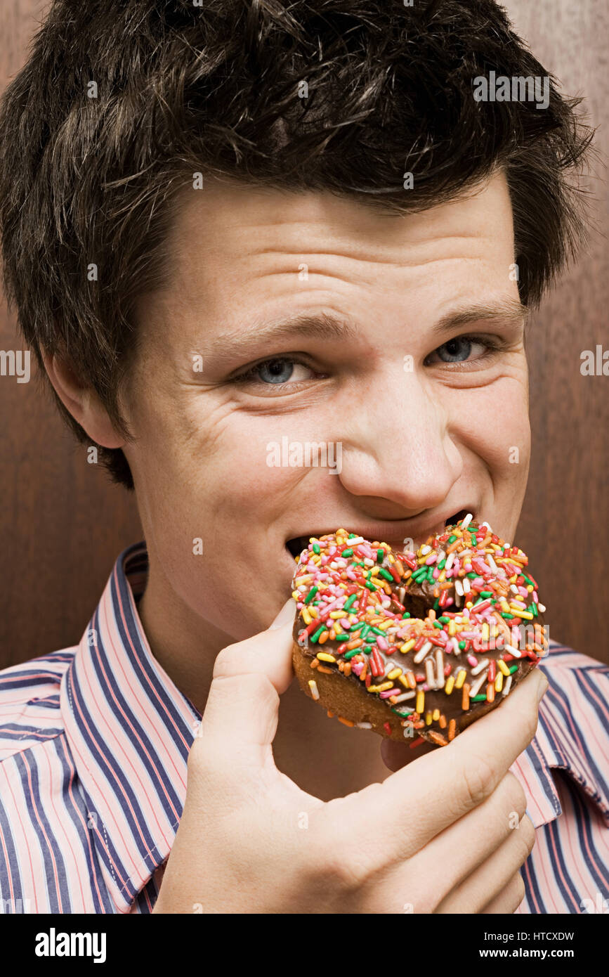 Businessman eating a doughnut Stock Photo - Alamy