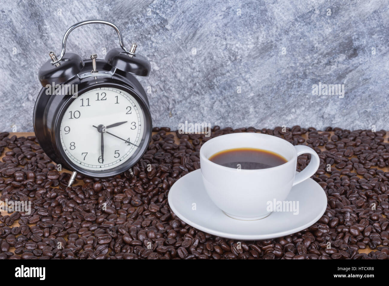 coffee in cup and vintage clock (Coffee time concept) with concrete ...