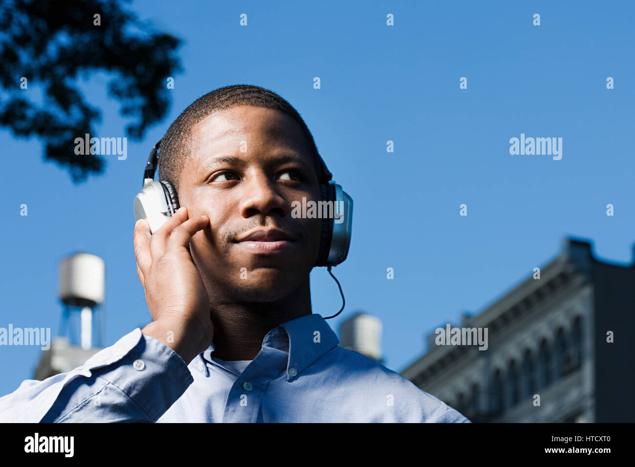 Man listening to headphones Stock Photo - Alamy