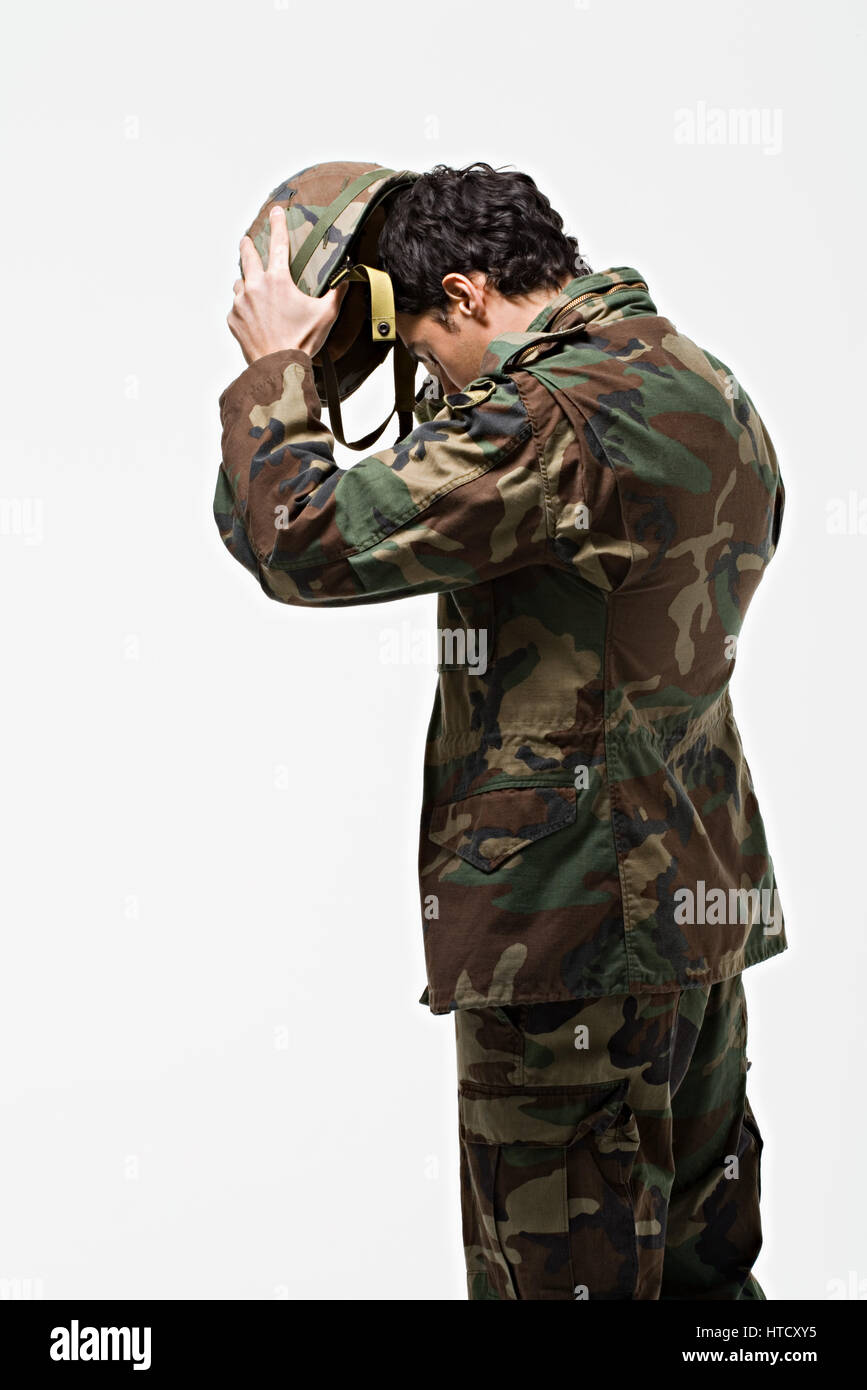 Soldier putting on helmet Stock Photo - Alamy