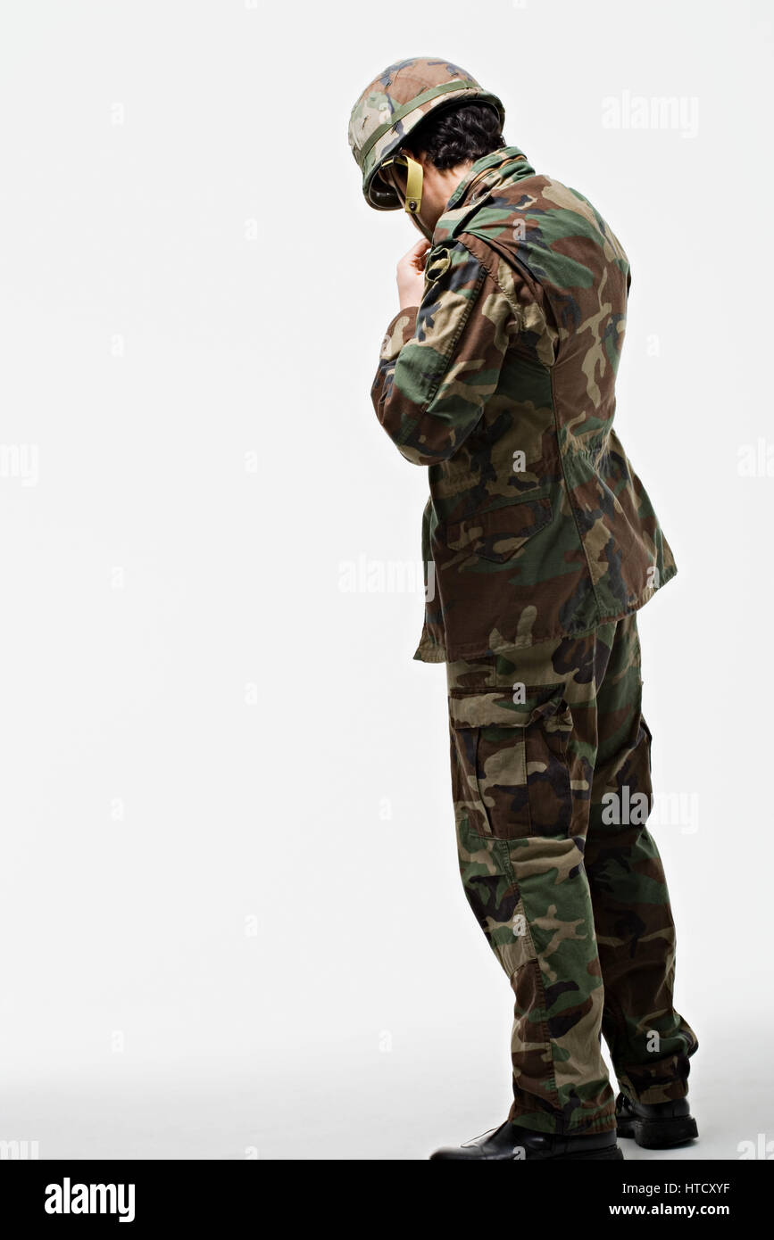 Soldier putting on helmet Stock Photo - Alamy
