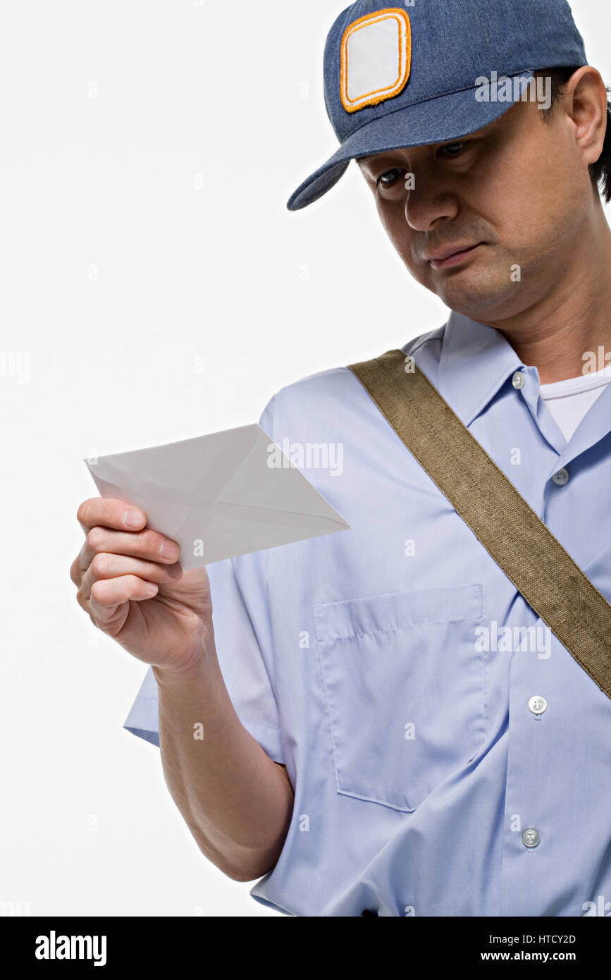 Postman holding a letter Stock Photo - Alamy