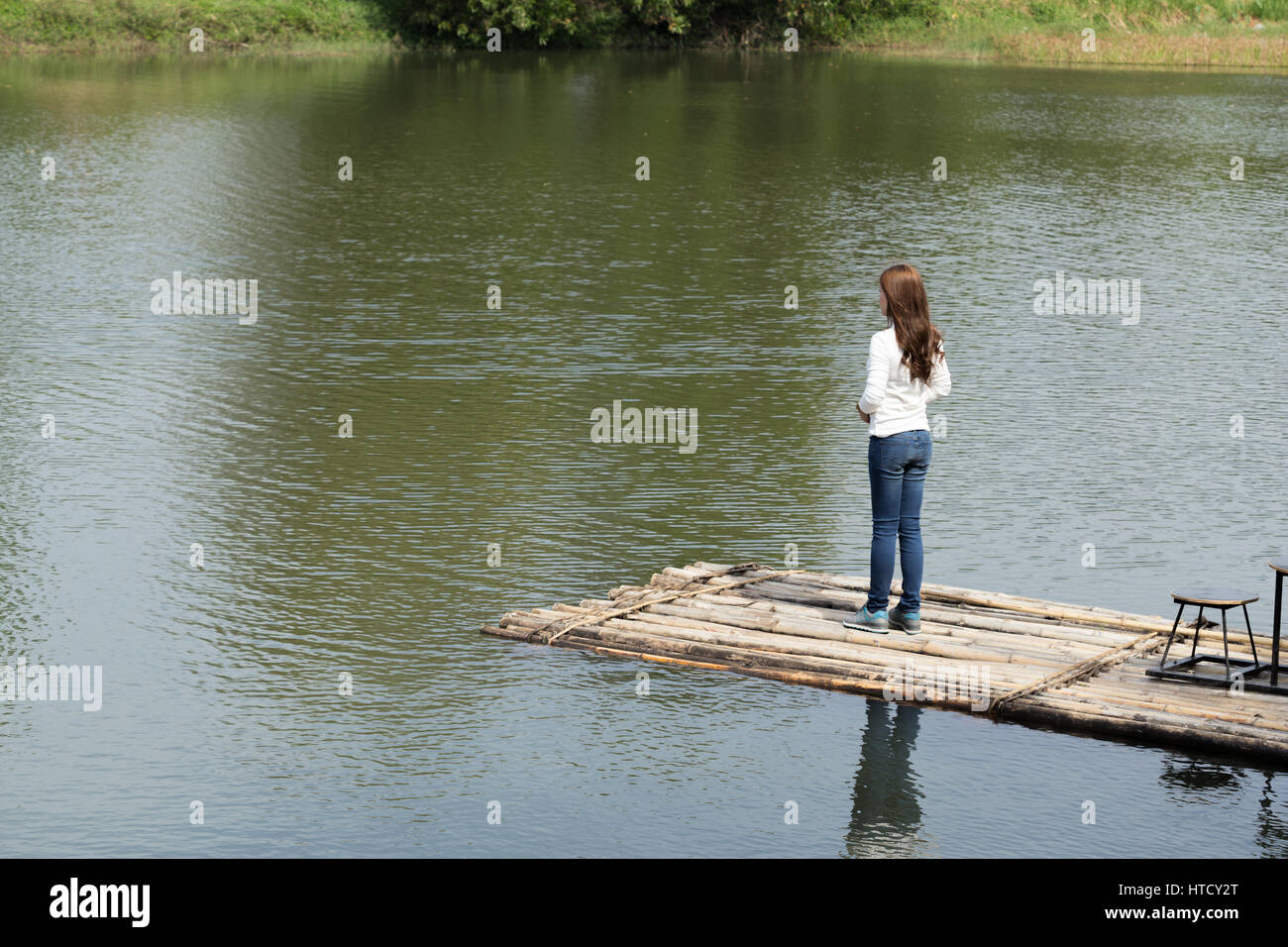 Woman on a bamboo raft in the river Stock Photo - Alamy