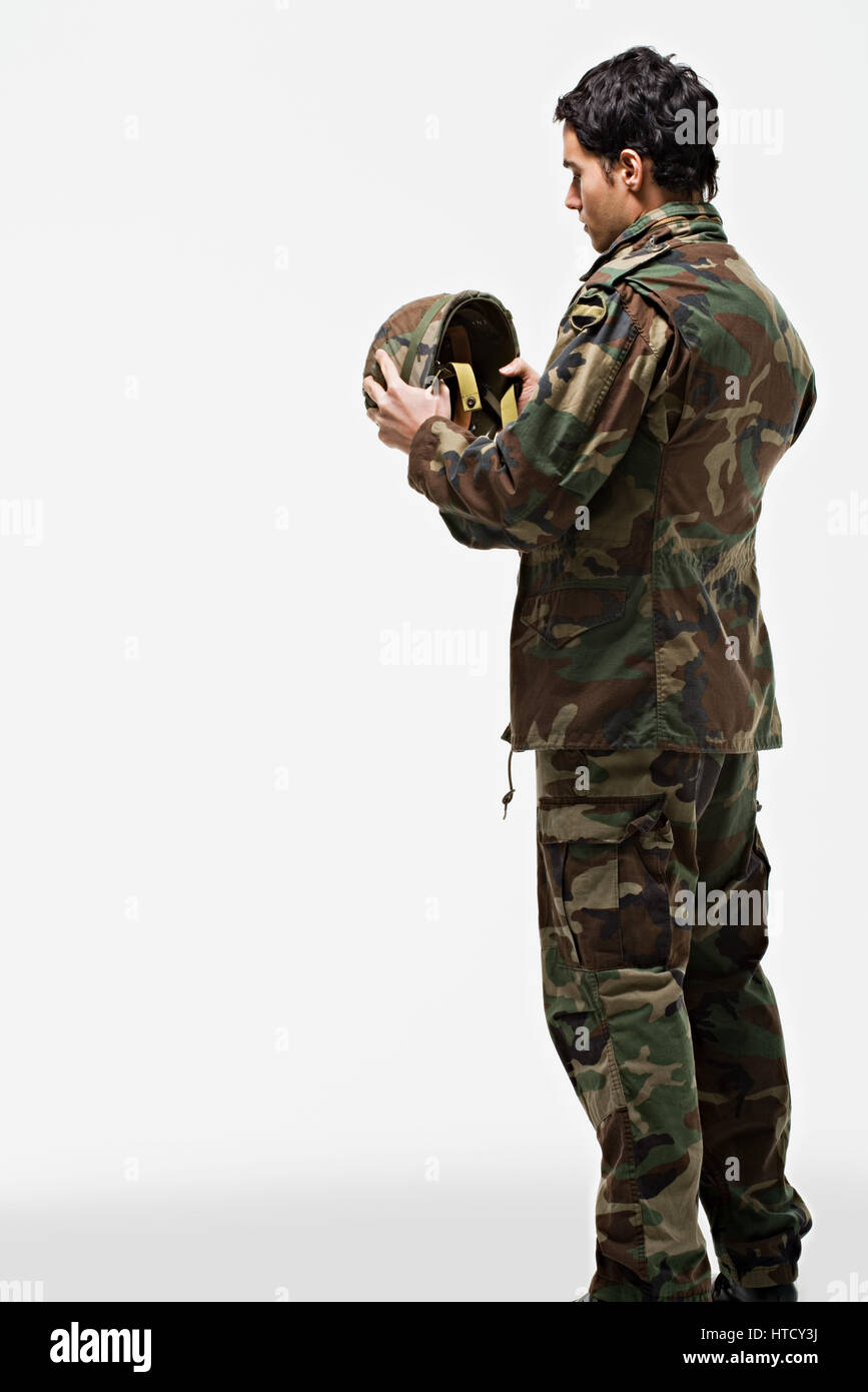 Soldier putting on helmet Stock Photo - Alamy