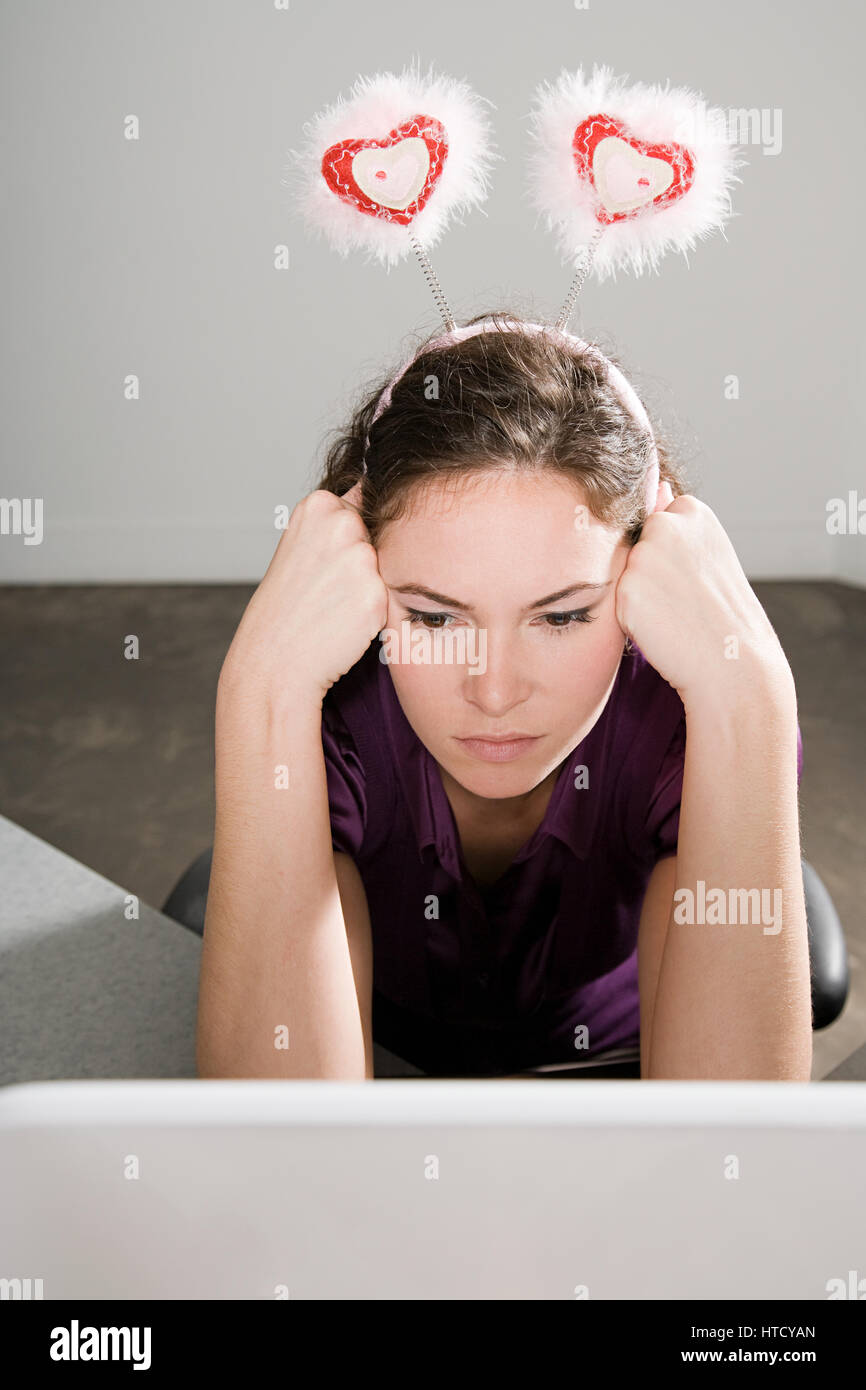 Depressed office worker wearing deely bopper Stock Photo - Alamy
