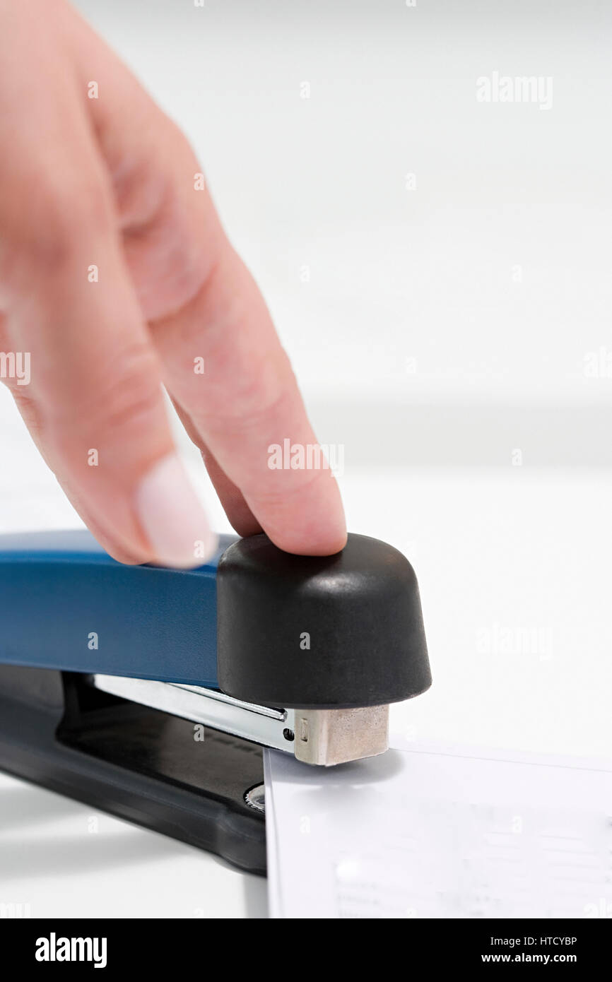 Person using stapler hi-res stock photography and images - Alamy