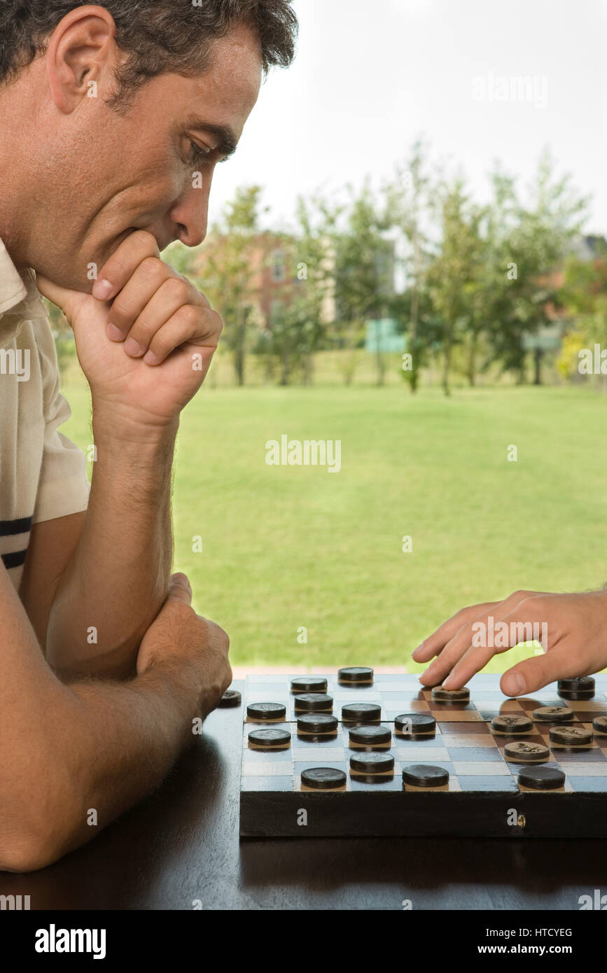 Man playing checkers Stock Photo - Alamy