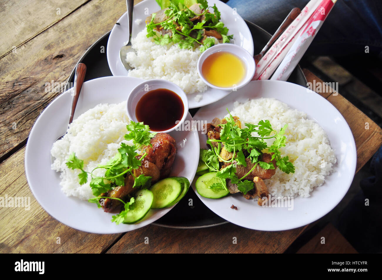 Vietnamese broken rice or com tam with fried chicken legs, pork and ...