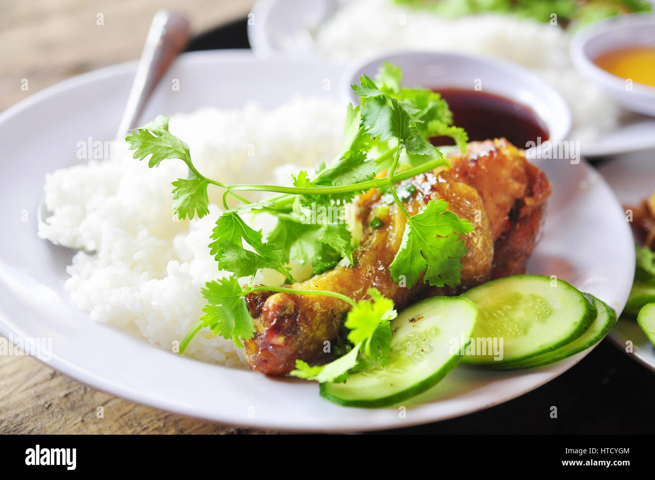 Vietnamese broken rice or com tam with fried chicken legs, pork and ...