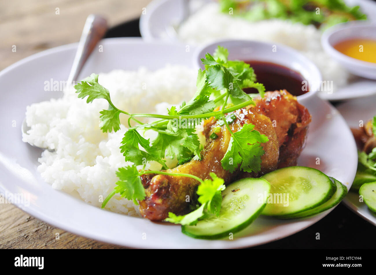Vietnamese broken rice or com tam with fried chicken legs, pork and ...