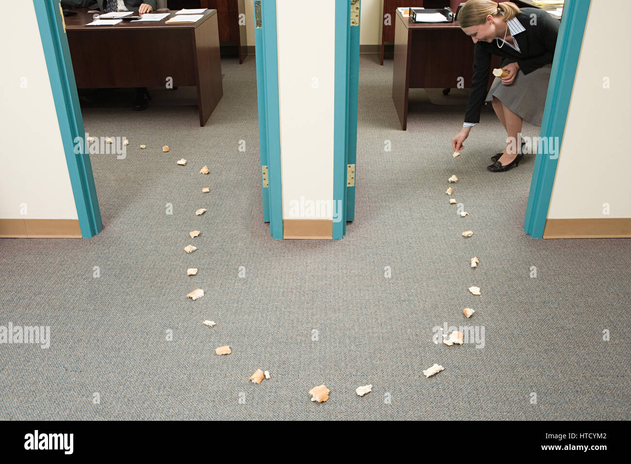 Woman placing trail of bread Stock Photo - Alamy