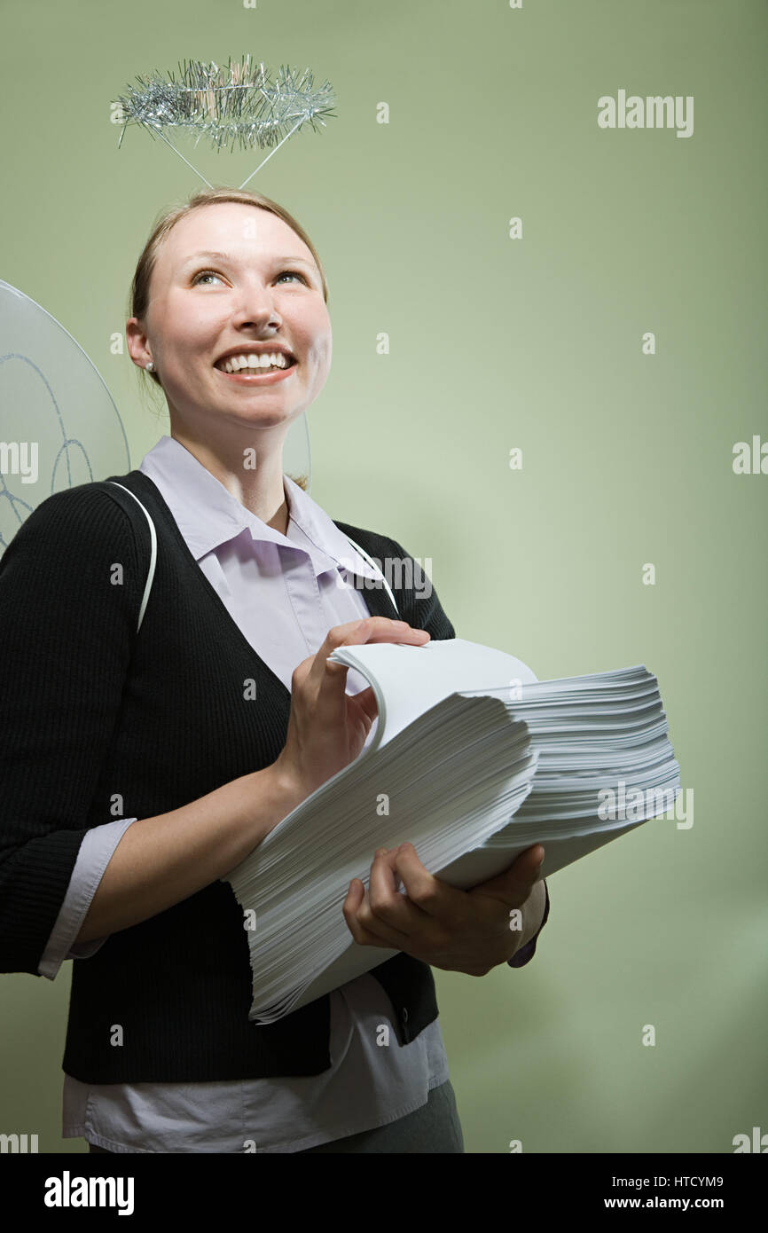 Office angel holding paperwork Stock Photo - Alamy