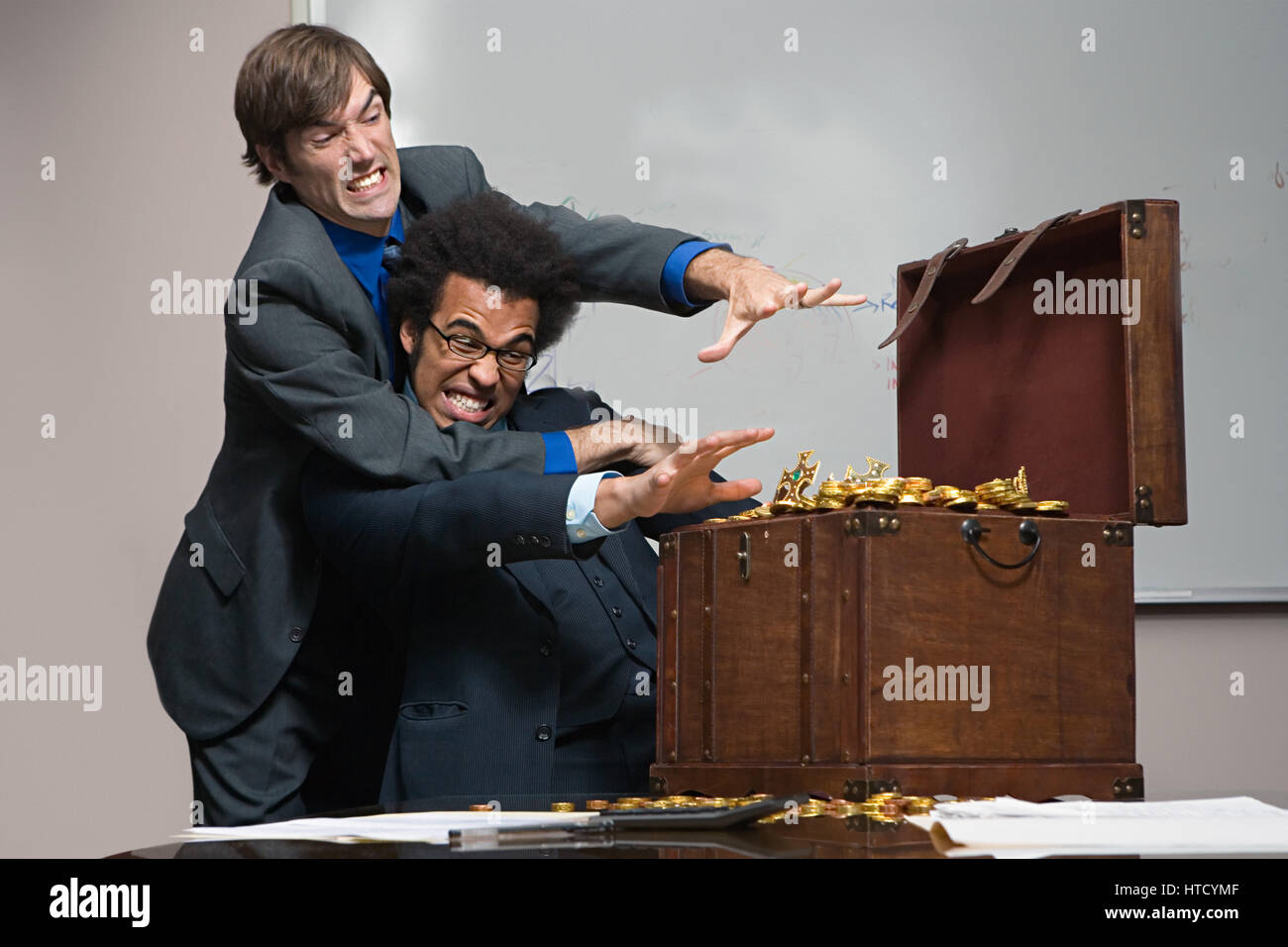 Colleagues fighting over money Stock Photo - Alamy