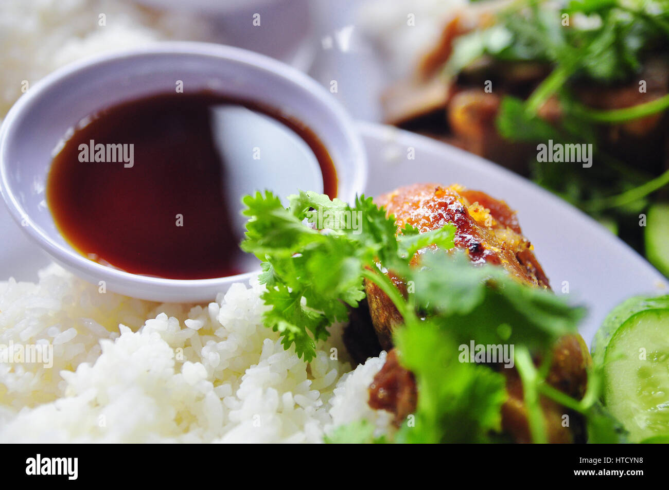 Vietnamese broken rice or com tam with fried chicken legs, pork and ...