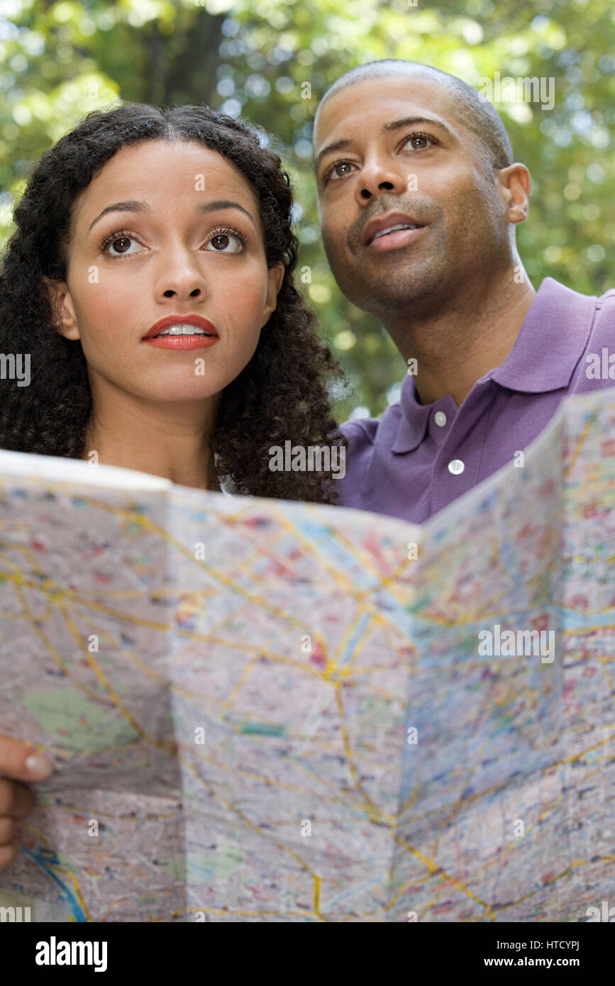 Couple with a map Stock Photo - Alamy
