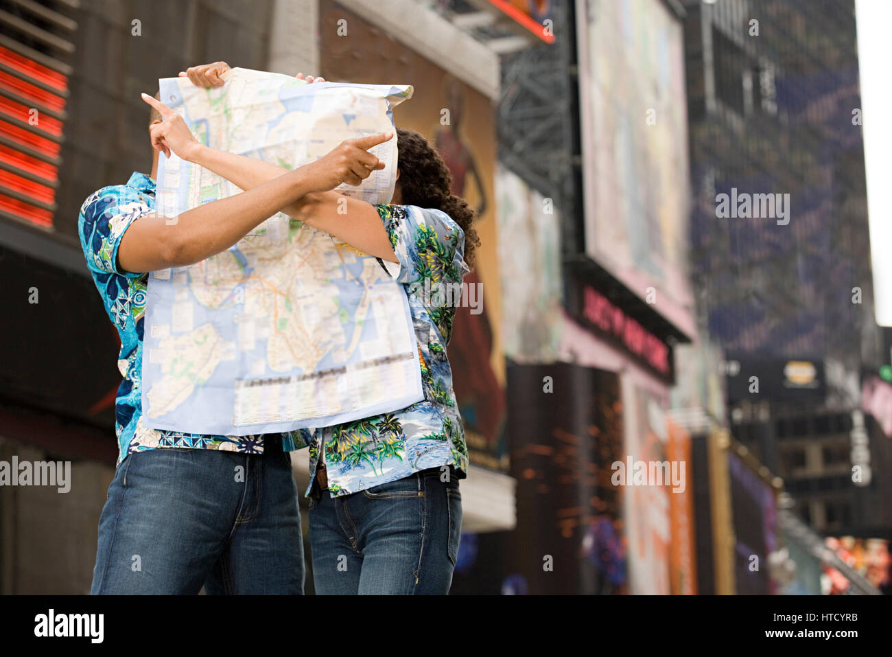Couple with a map Stock Photo - Alamy