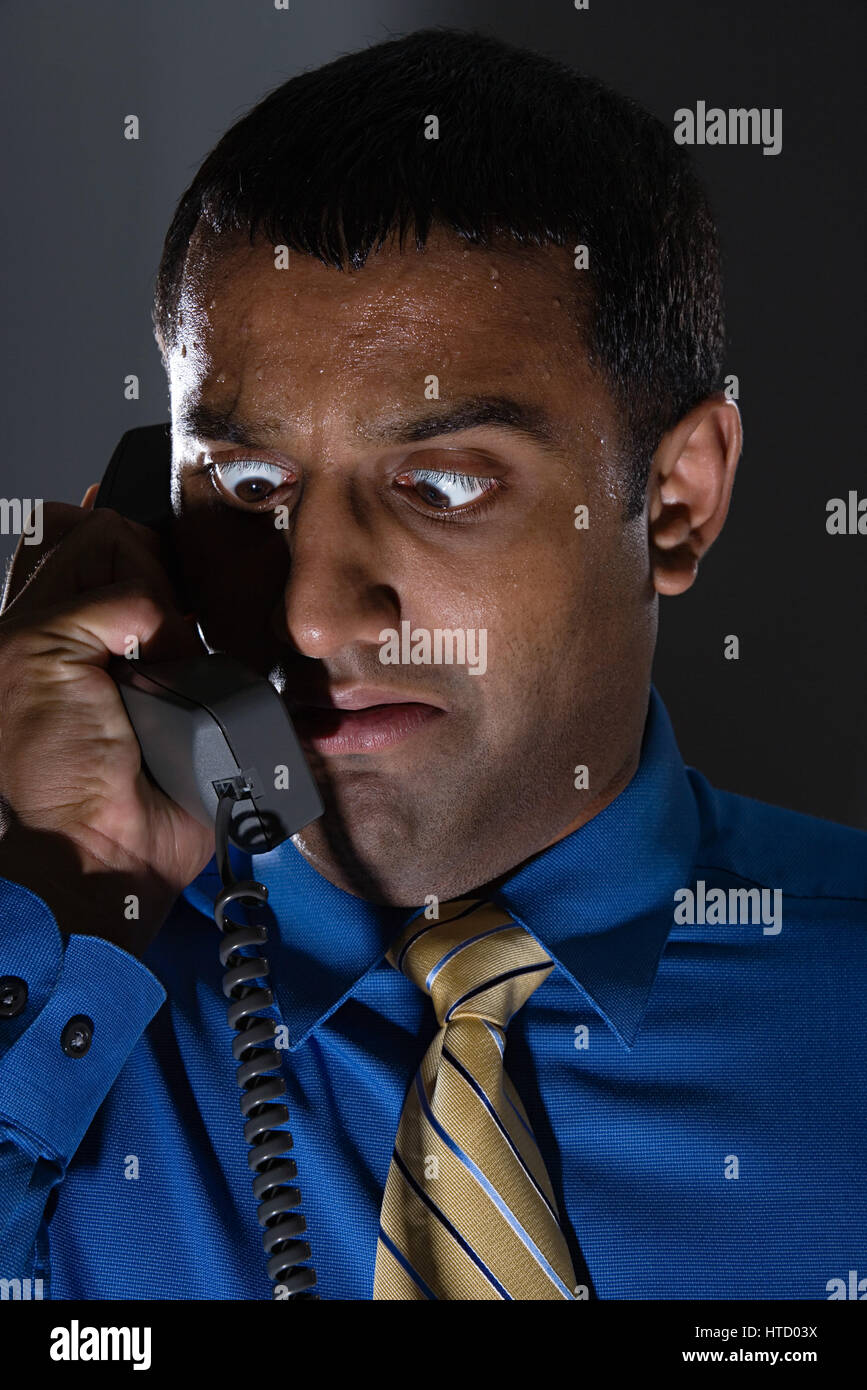 Terrified man on phone Stock Photo - Alamy