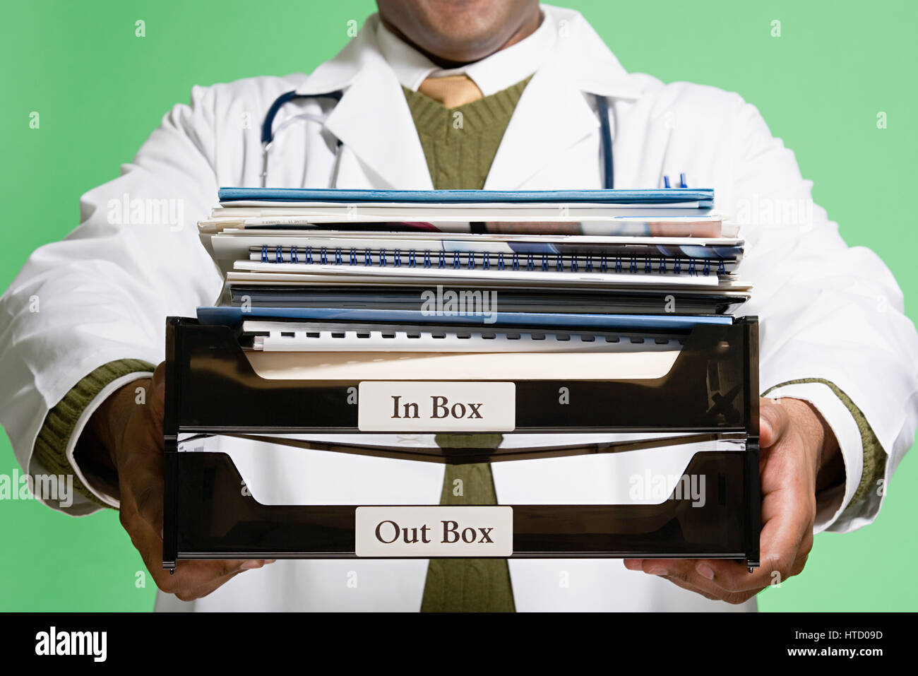 Doctor holding a stack of paperwork Stock Photo - Alamy
