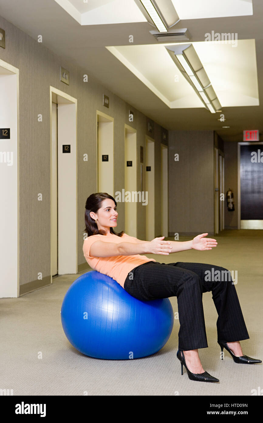 Female office using exercise ball hi-res stock photography and images ...