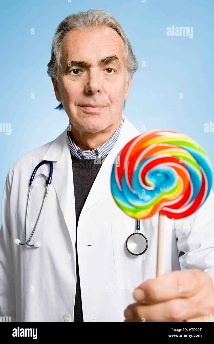 Doctor holding a lollipop Stock Photo - Alamy