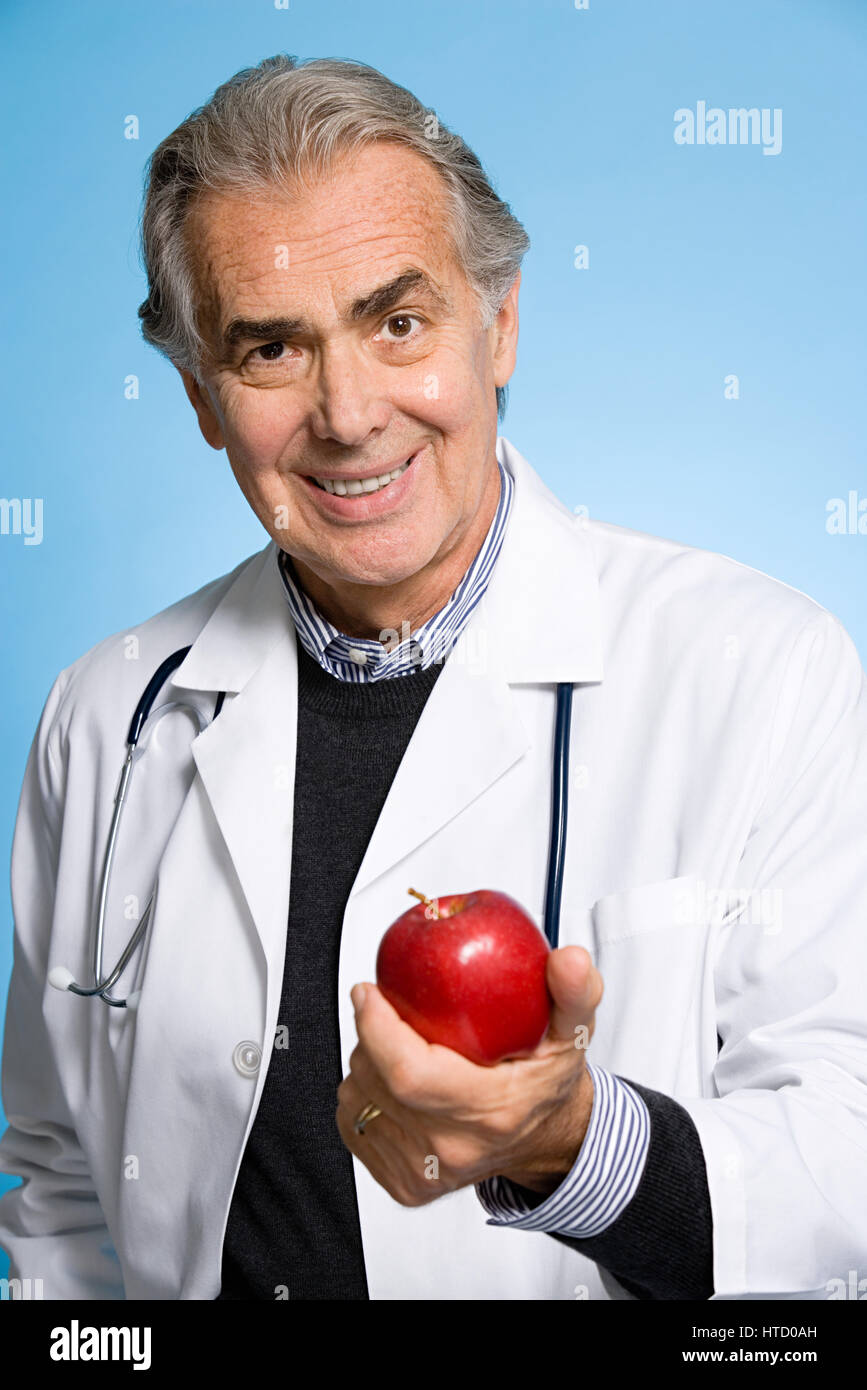 Doctor holding an apple Stock Photo - Alamy