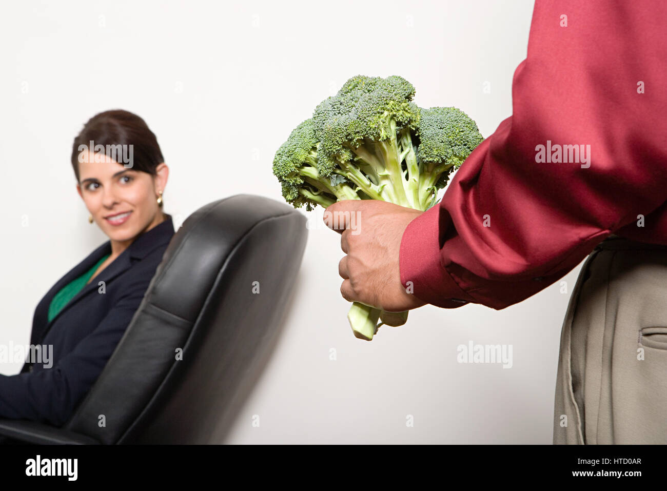 Man holding a bunch of broccoli Stock Photo - Alamy