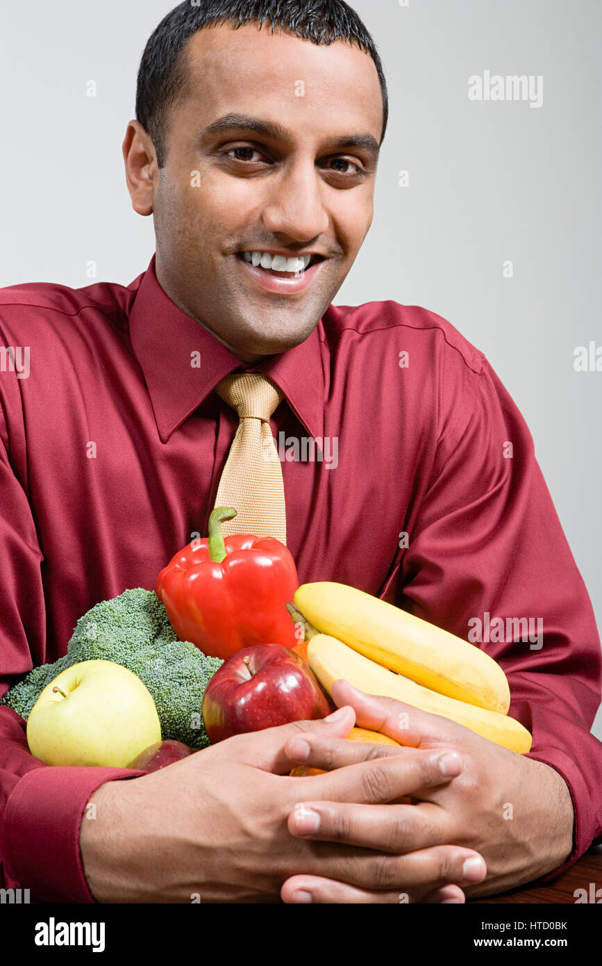 Man holding fruit and vegetables Stock Photo - Alamy