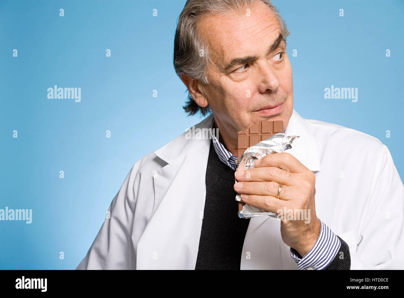 Doctor eating chocolate Stock Photo - Alamy