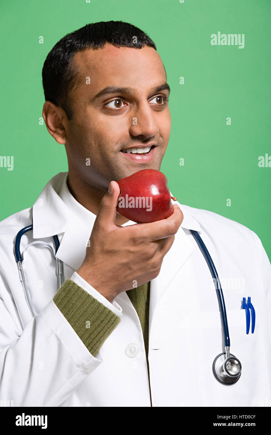 Doctor eating an apple Stock Photo - Alamy