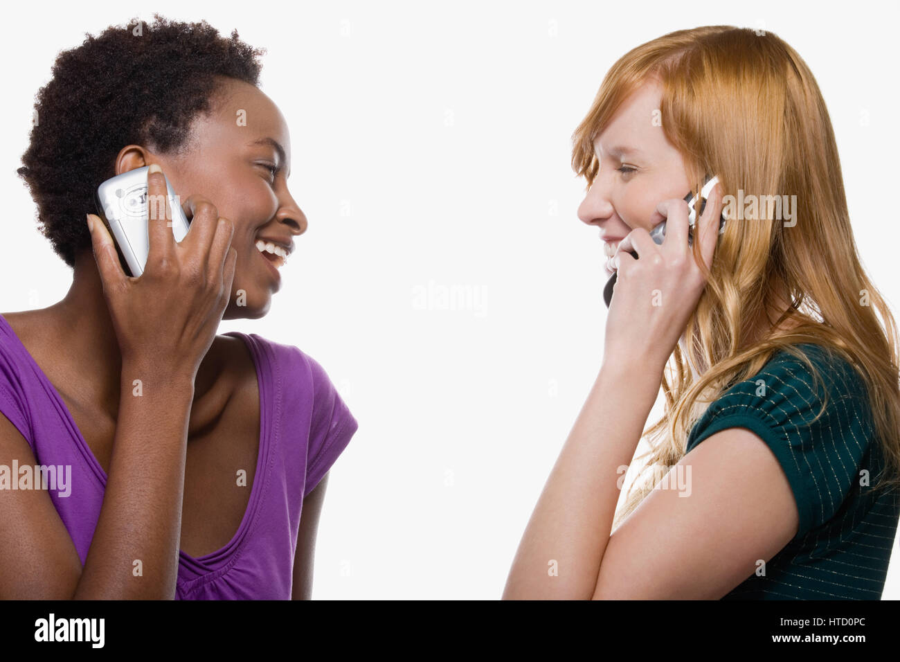 Friends using cell phone Stock Photo - Alamy